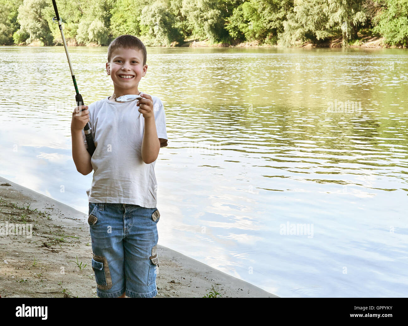boy catch fish on bait, child camping and fishing, river and forest ...