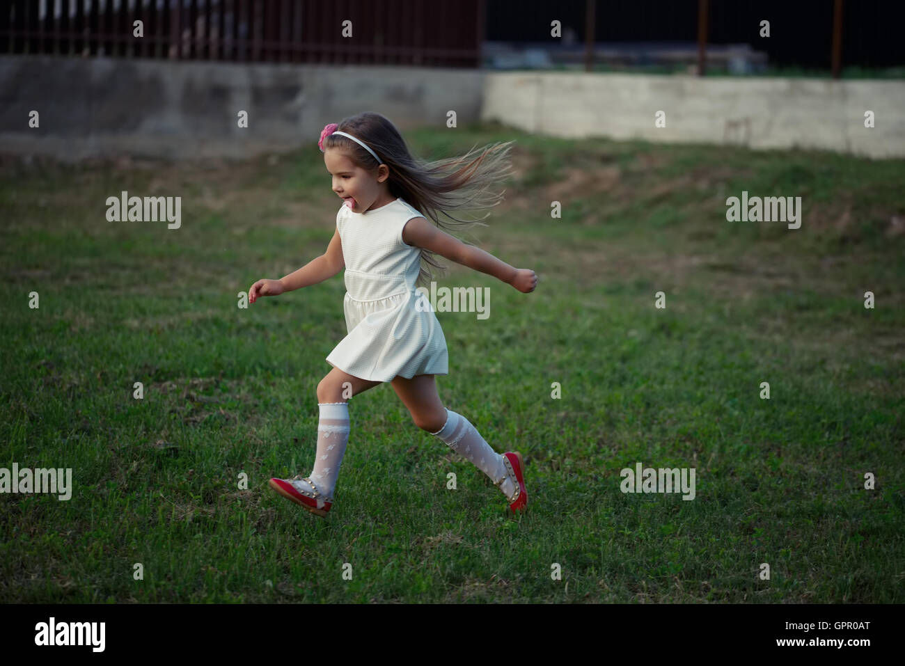 little beautiful running girl outside Stock Photo - Alamy