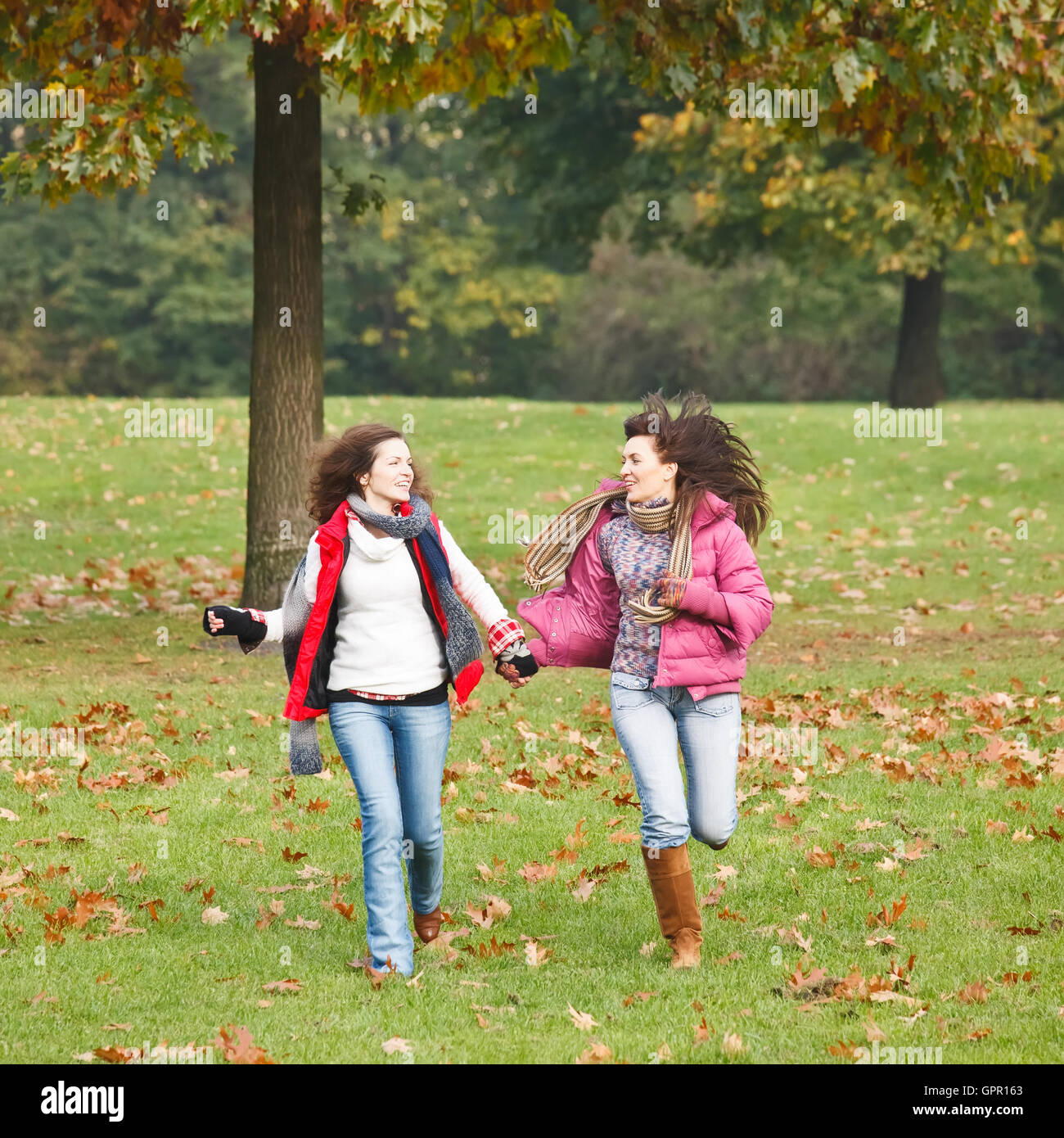 Two pretty girls in the park Stock Photo - Alamy