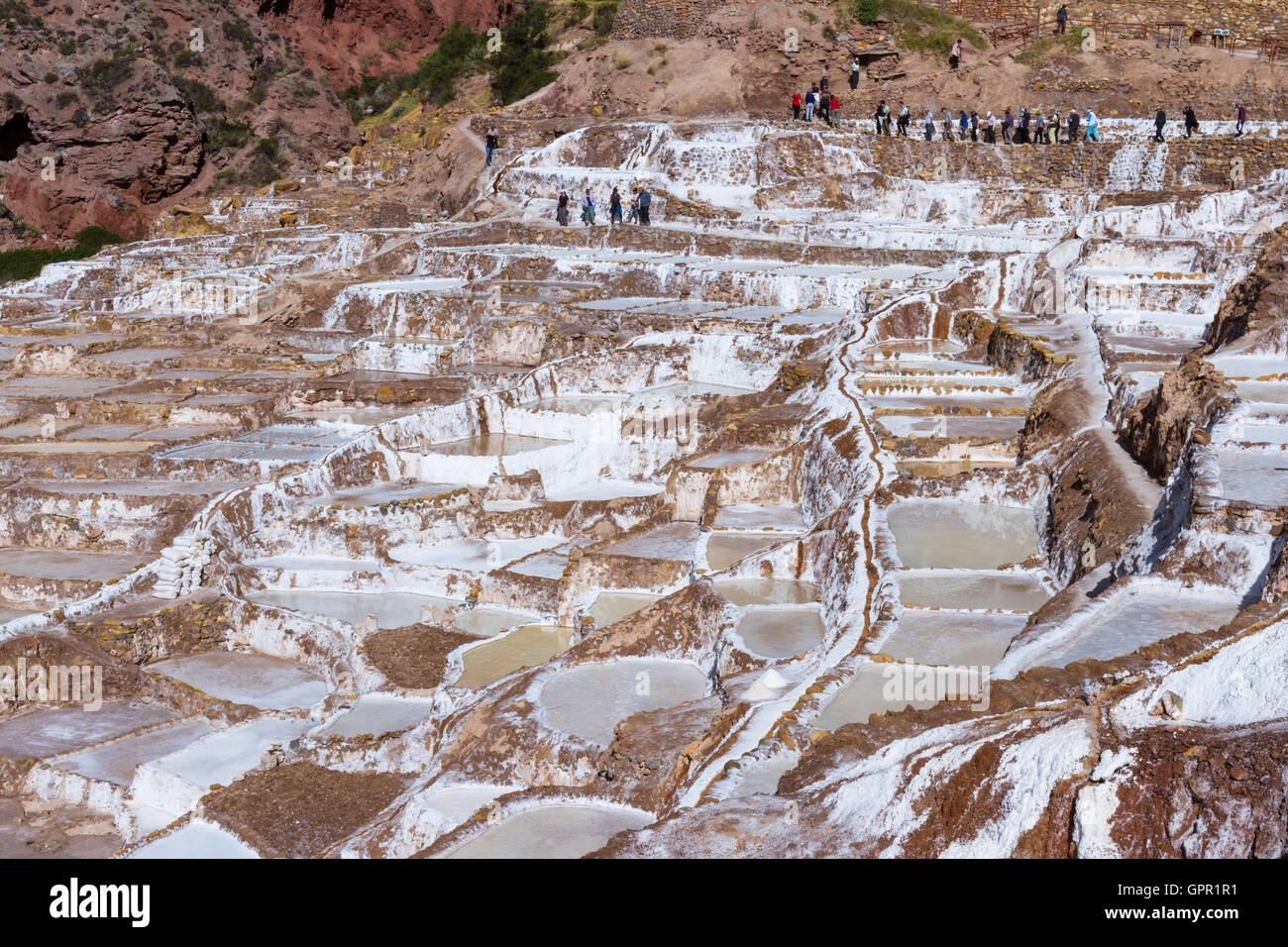Maras Peru -May 18 : Tourists walking exploring the salt ponds in Maras ...