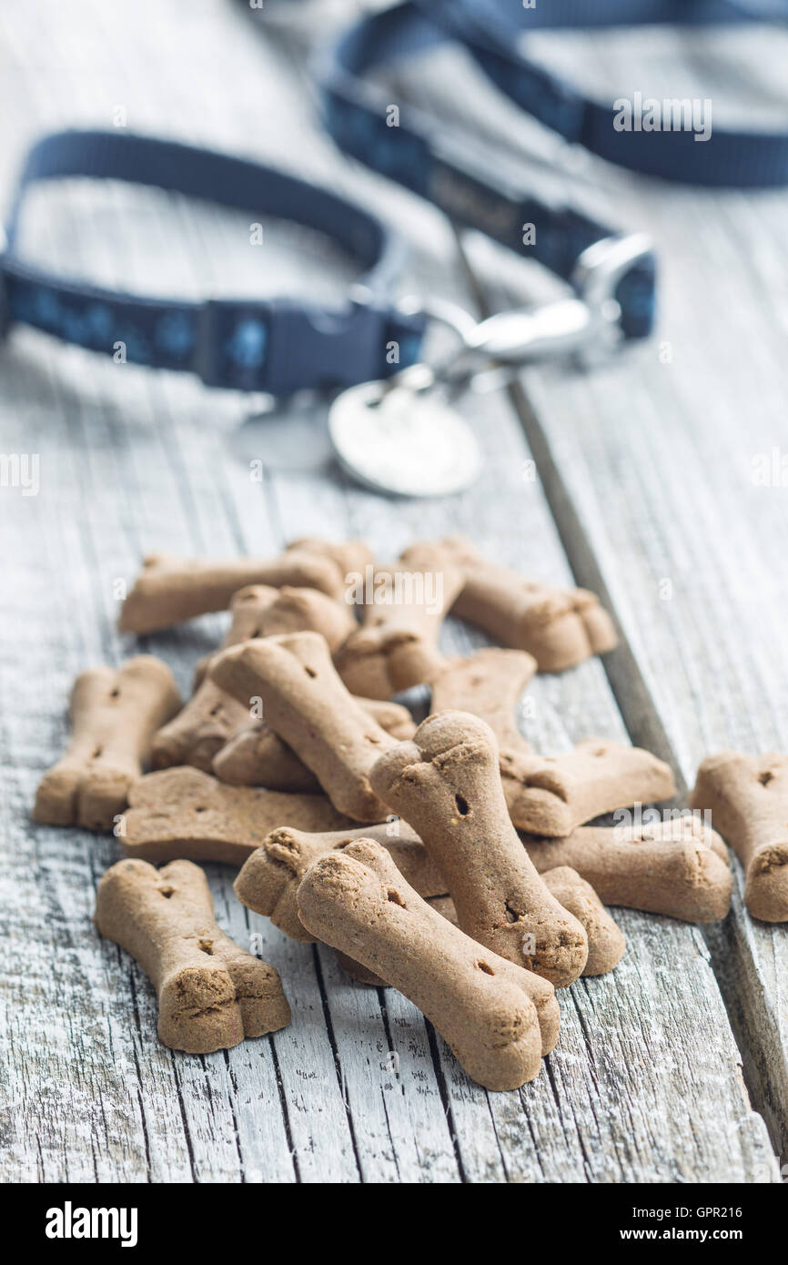 Dog food shaped like bones on old wooden table Stock Photo - Alamy