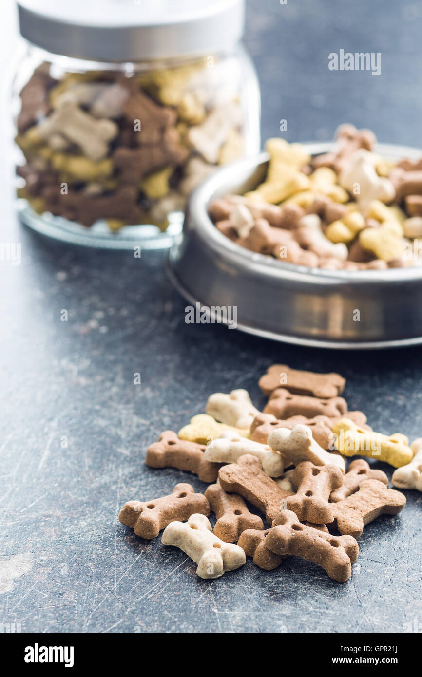 Dog food shaped like bones on old table Stock Photo - Alamy