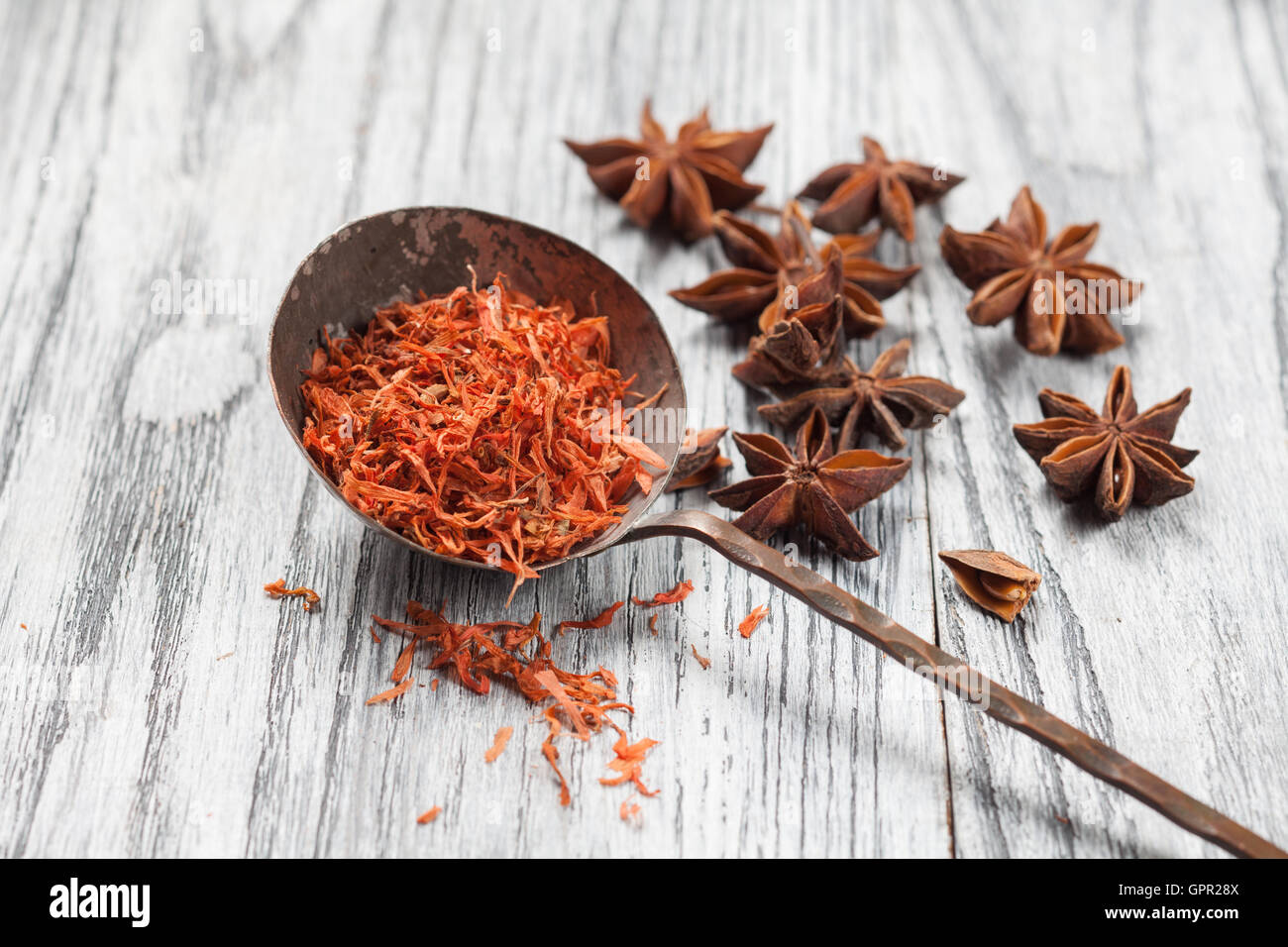 Saffron in white spoon on black table hi-res stock photography and ...