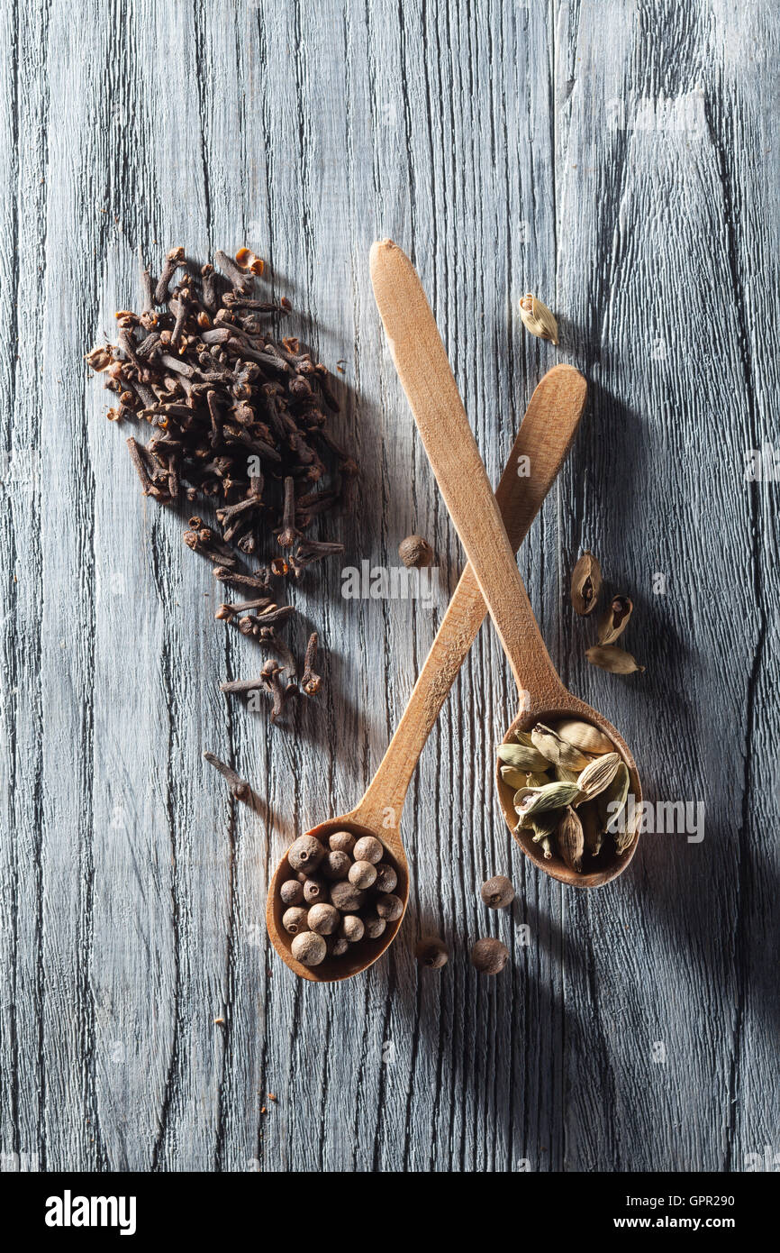 Nutmeg, clove and allspice in old spoon on wood Stock Photo - Alamy