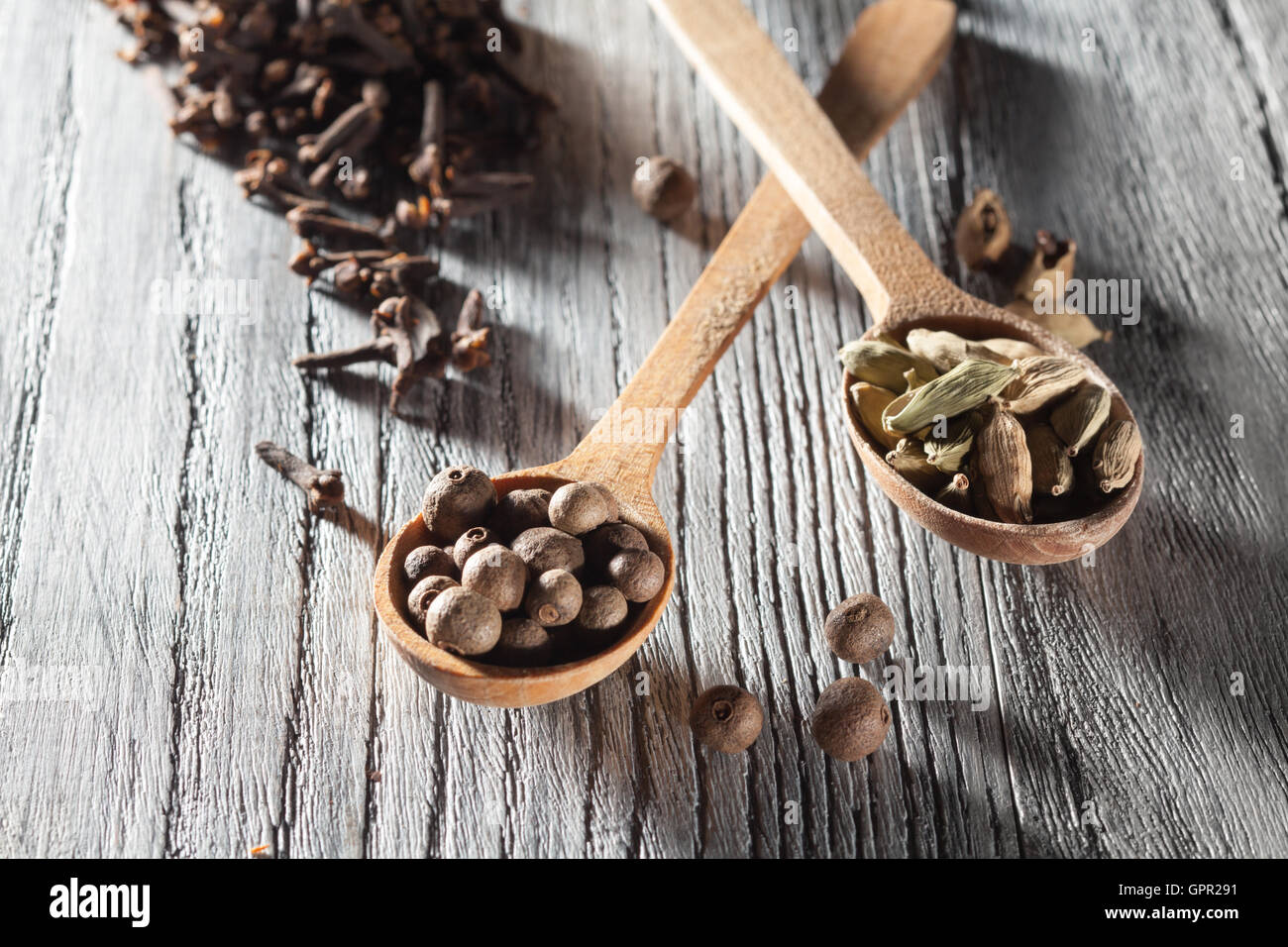 Nutmeg, clove and allspice in old spoon on wood Stock Photo - Alamy