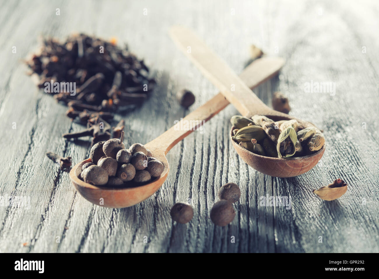 Nutmeg, clove and allspice in old spoon on wood Stock Photo - Alamy