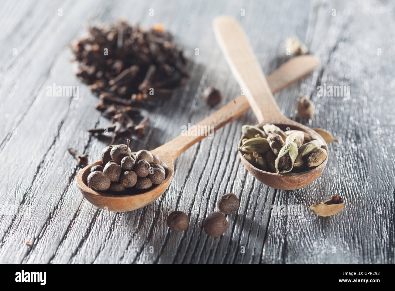 Nutmeg, clove and allspice in old spoon on wood Stock Photo - Alamy