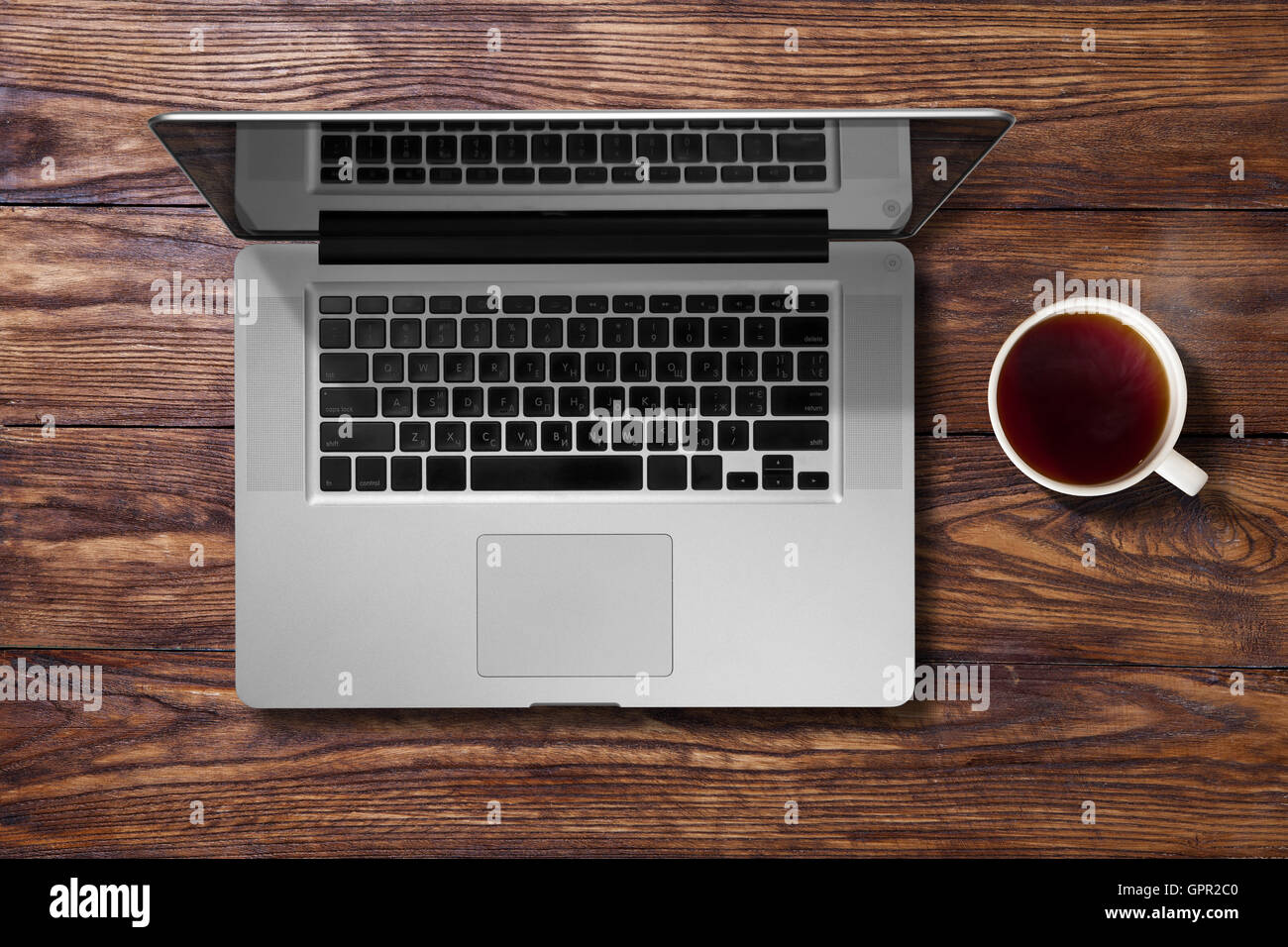 Open laptop and cup of tea Stock Photo - Alamy