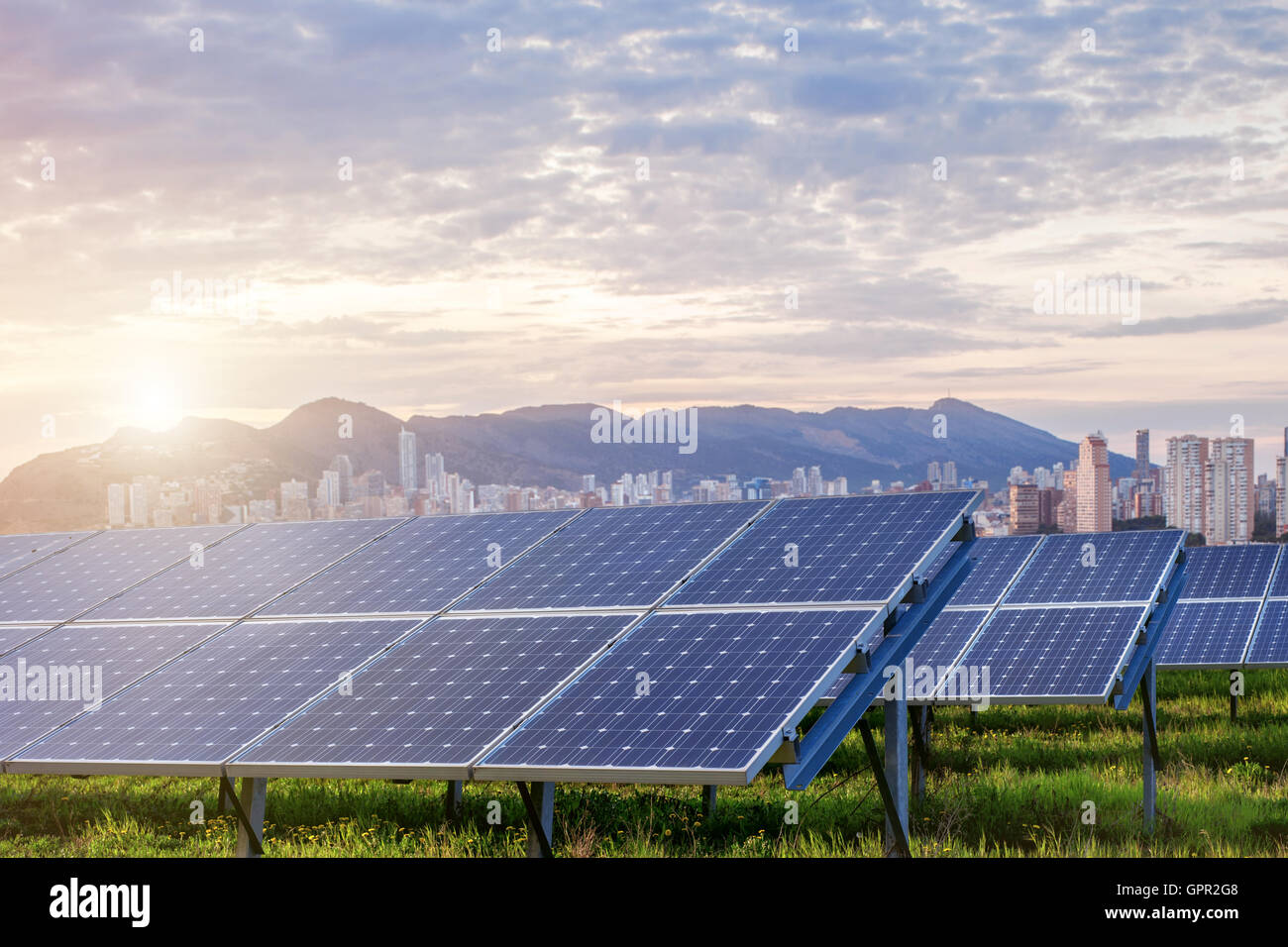 Solar panels with city on background Stock Photo - Alamy
