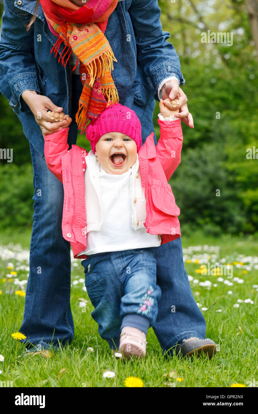 Baby's first steps Stock Photo - Alamy