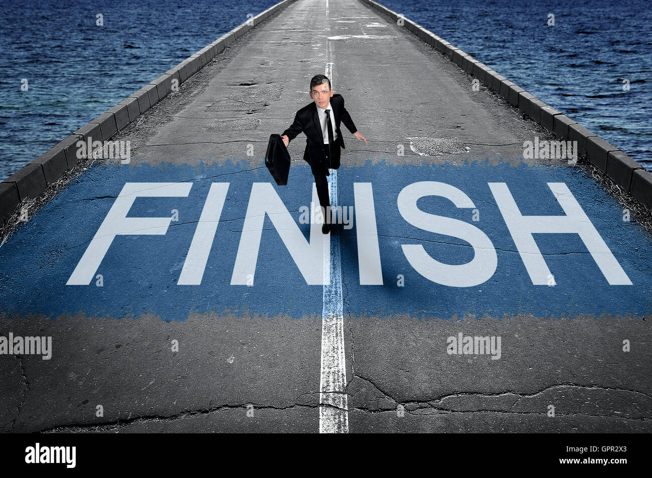 Finish line on road and business man Stock Photo - Alamy
