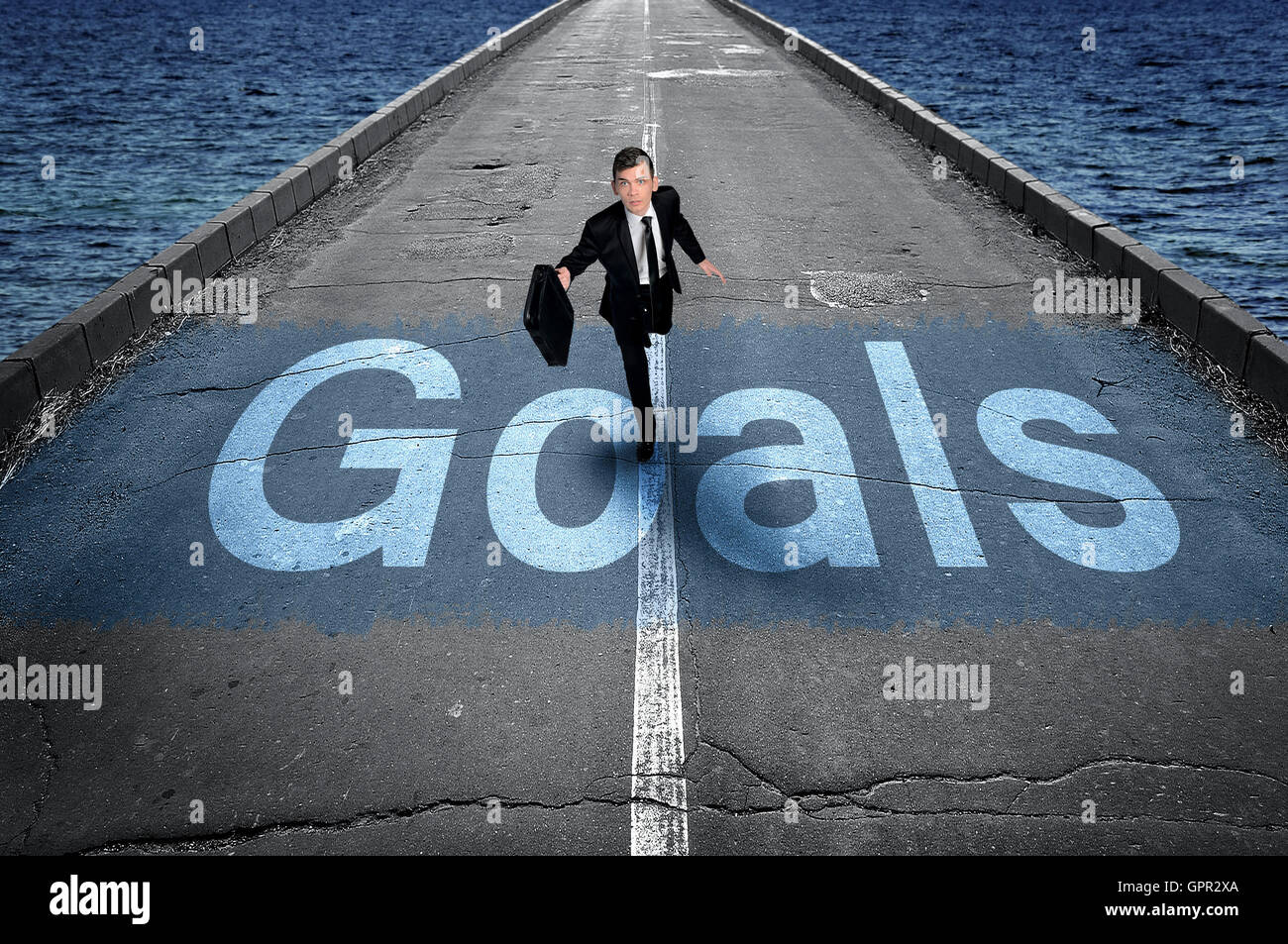 Goals message on road and business man Stock Photo - Alamy