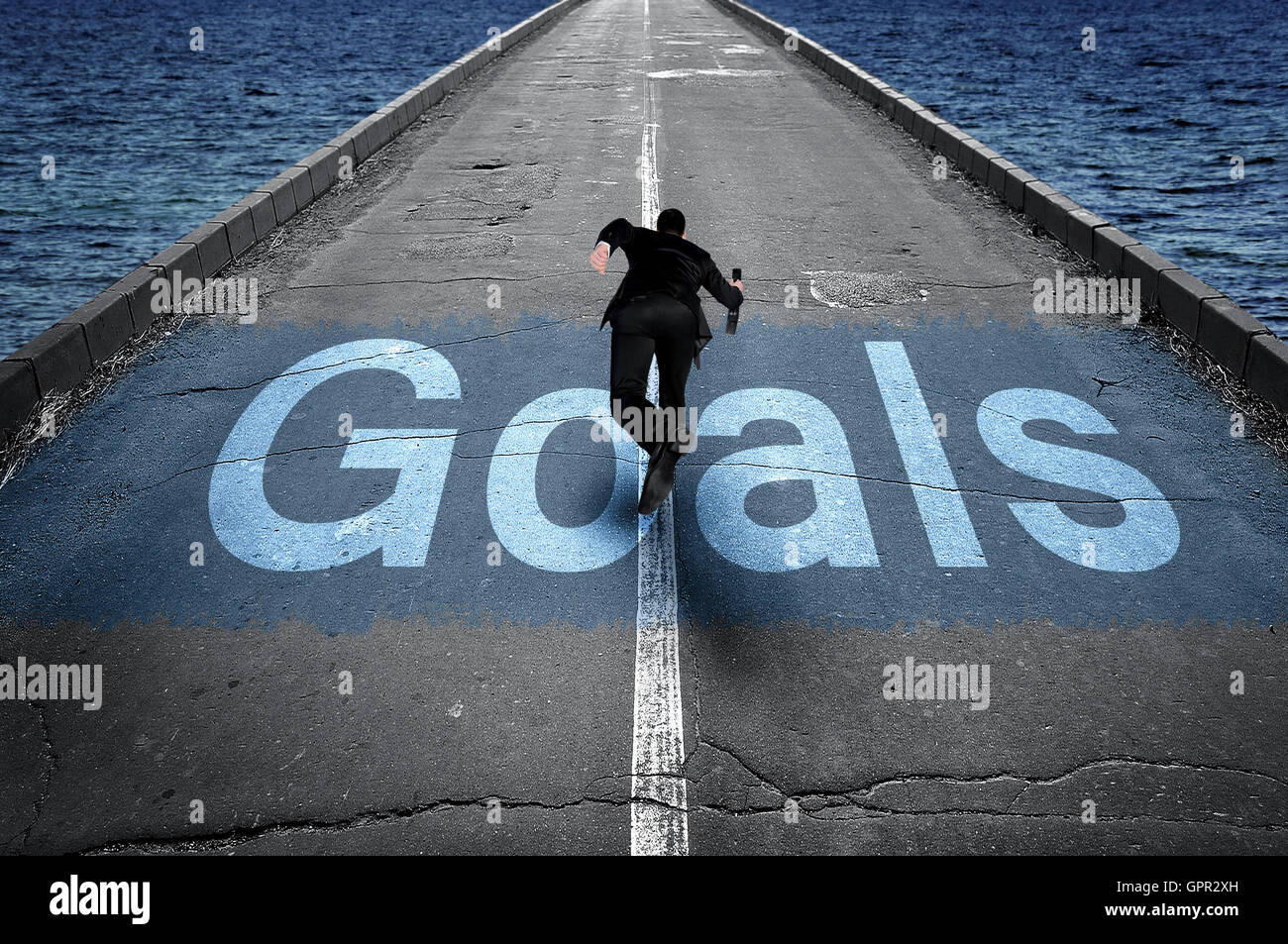 Goals message on road and business man Stock Photo - Alamy