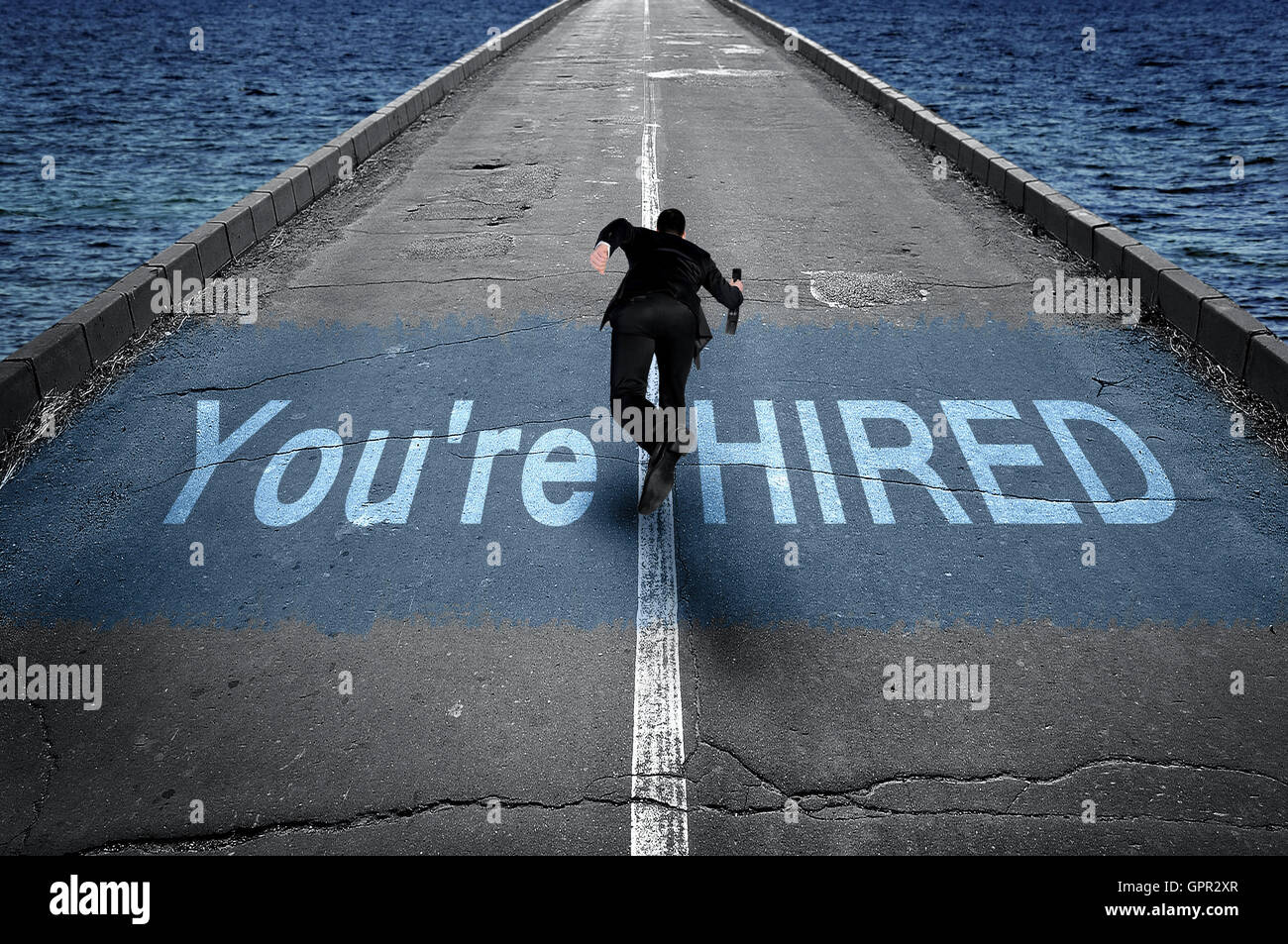 You're hired message on road and business man Stock Photo - Alamy