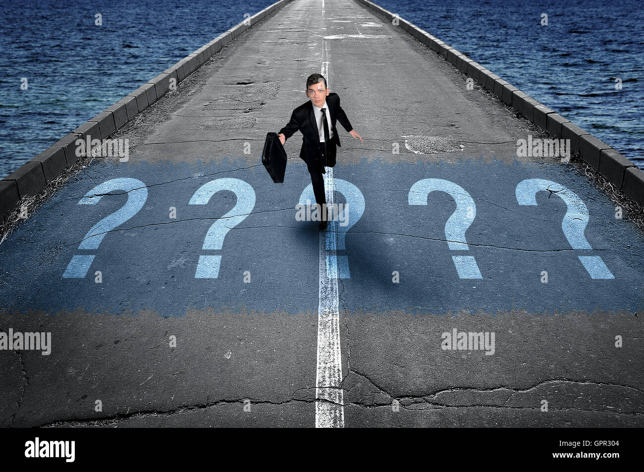 Question marks message on road and business man Stock Photo - Alamy