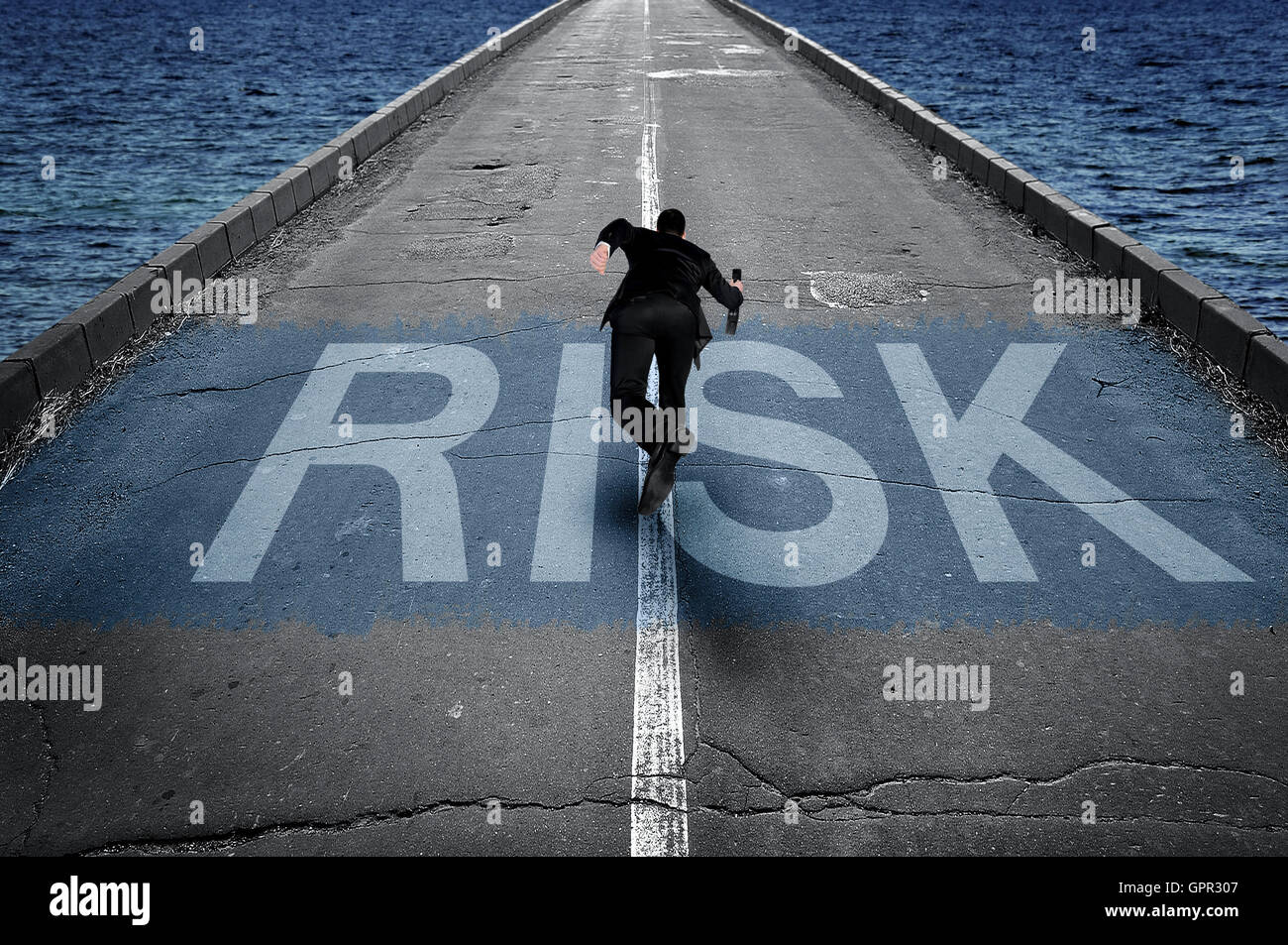 Risk message on road and business man Stock Photo - Alamy