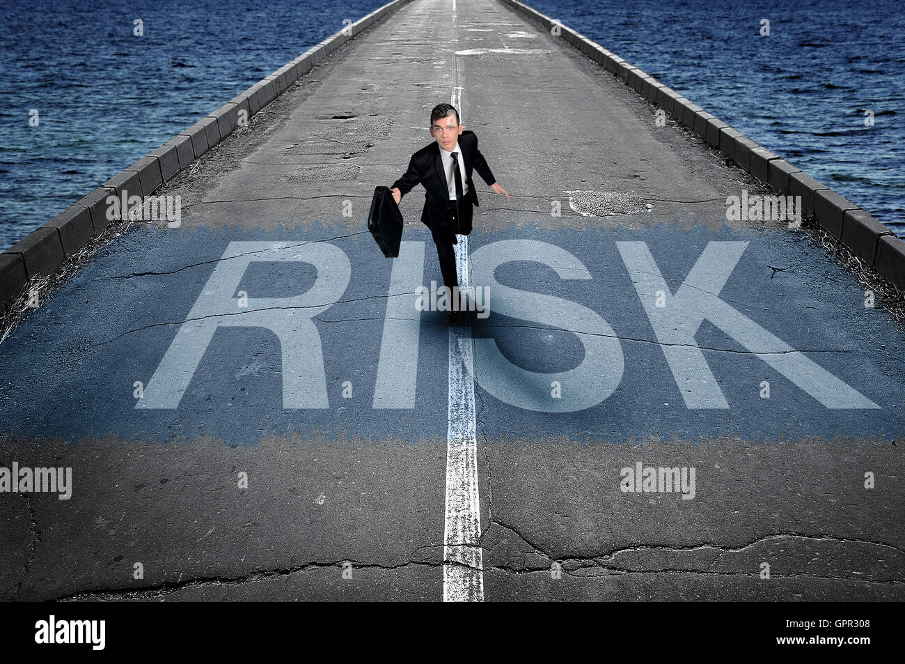 Risk message on road and business man Stock Photo - Alamy