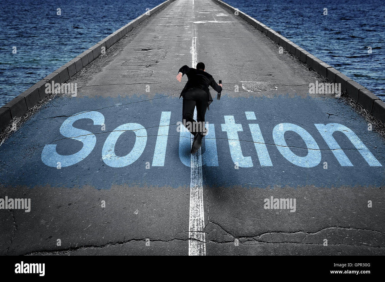 Solution message on road and business man Stock Photo - Alamy