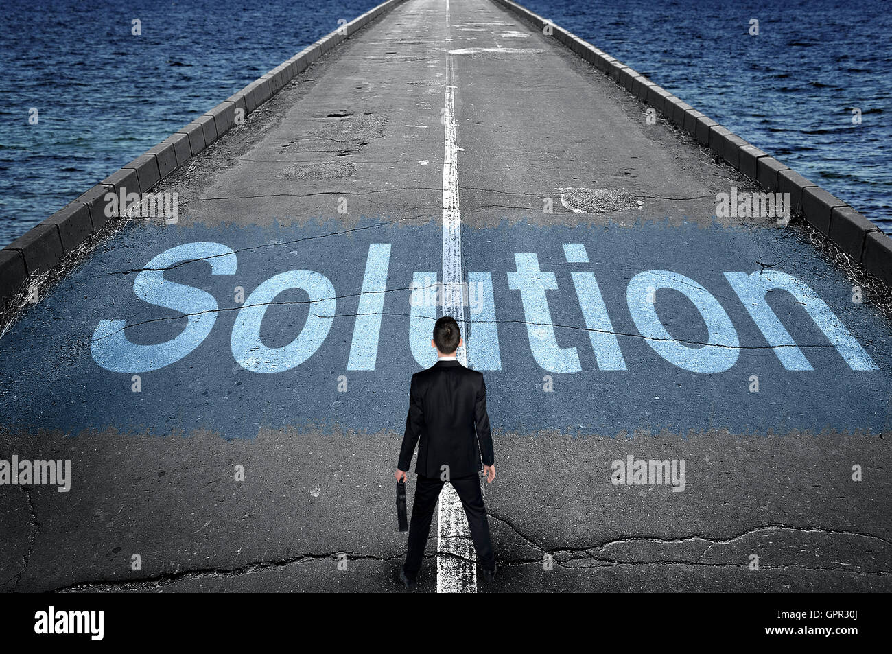 Solution message on road and business man Stock Photo - Alamy