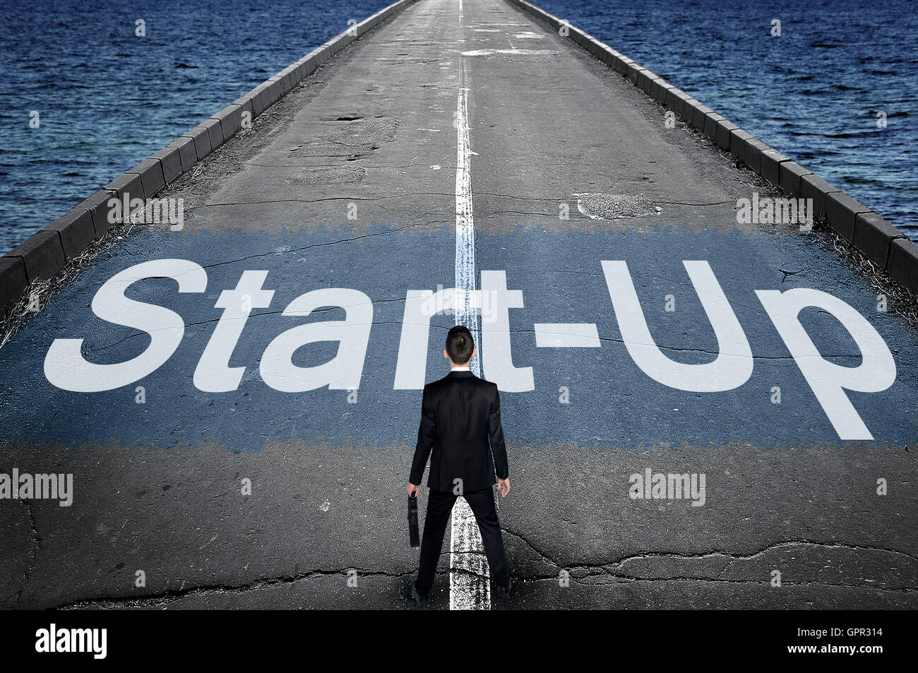 Start-up message on road and business man Stock Photo - Alamy