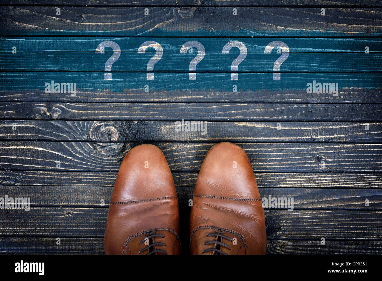 Question marks message and business shoes on wooden floor Stock Photo ...