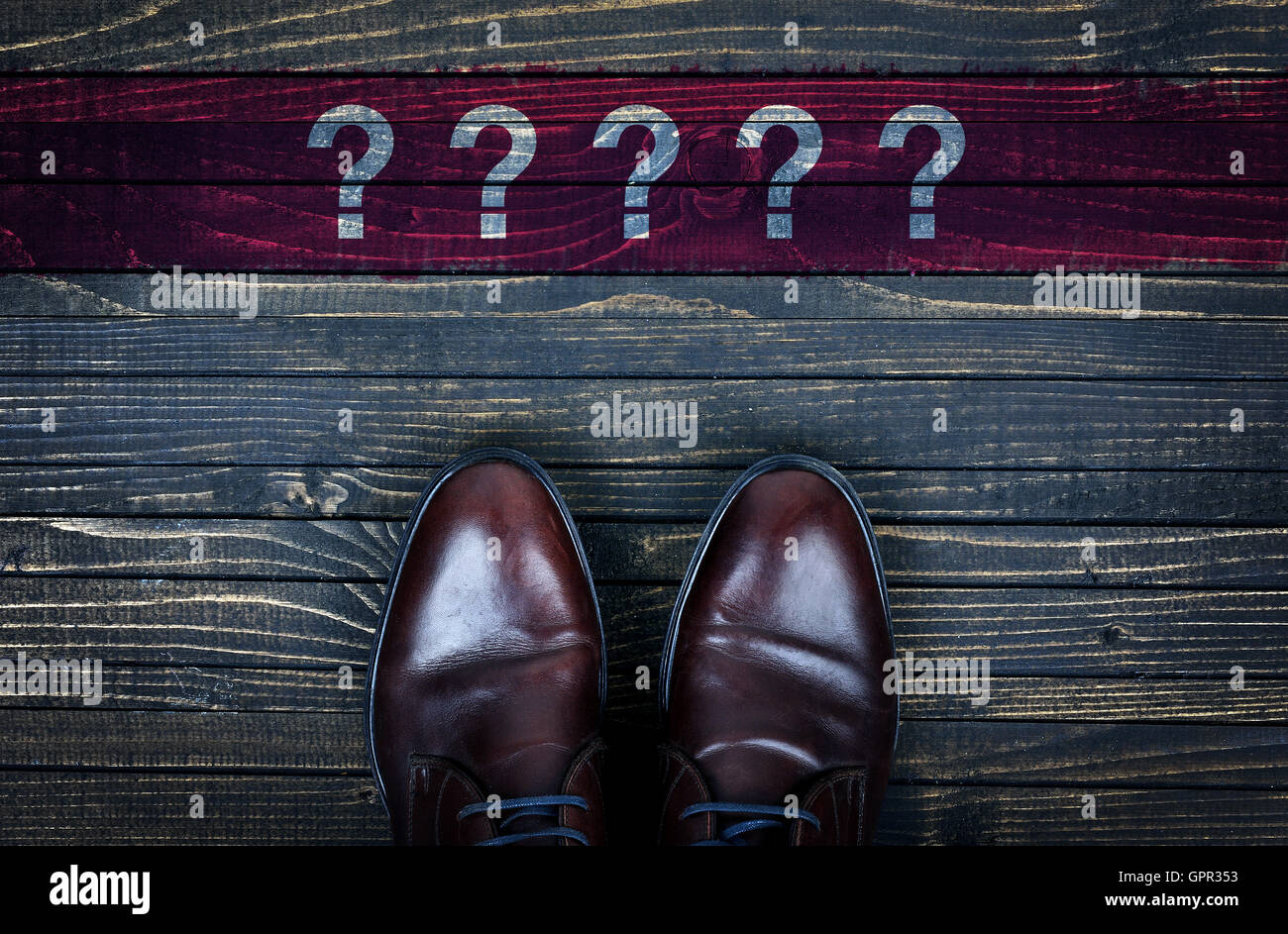 Question marks message and business shoes on wooden floor Stock Photo ...