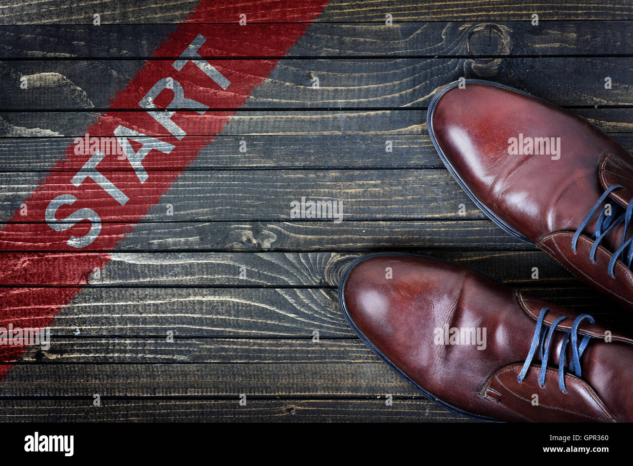 Start message and business shoes on wooden floor Stock Photo - Alamy