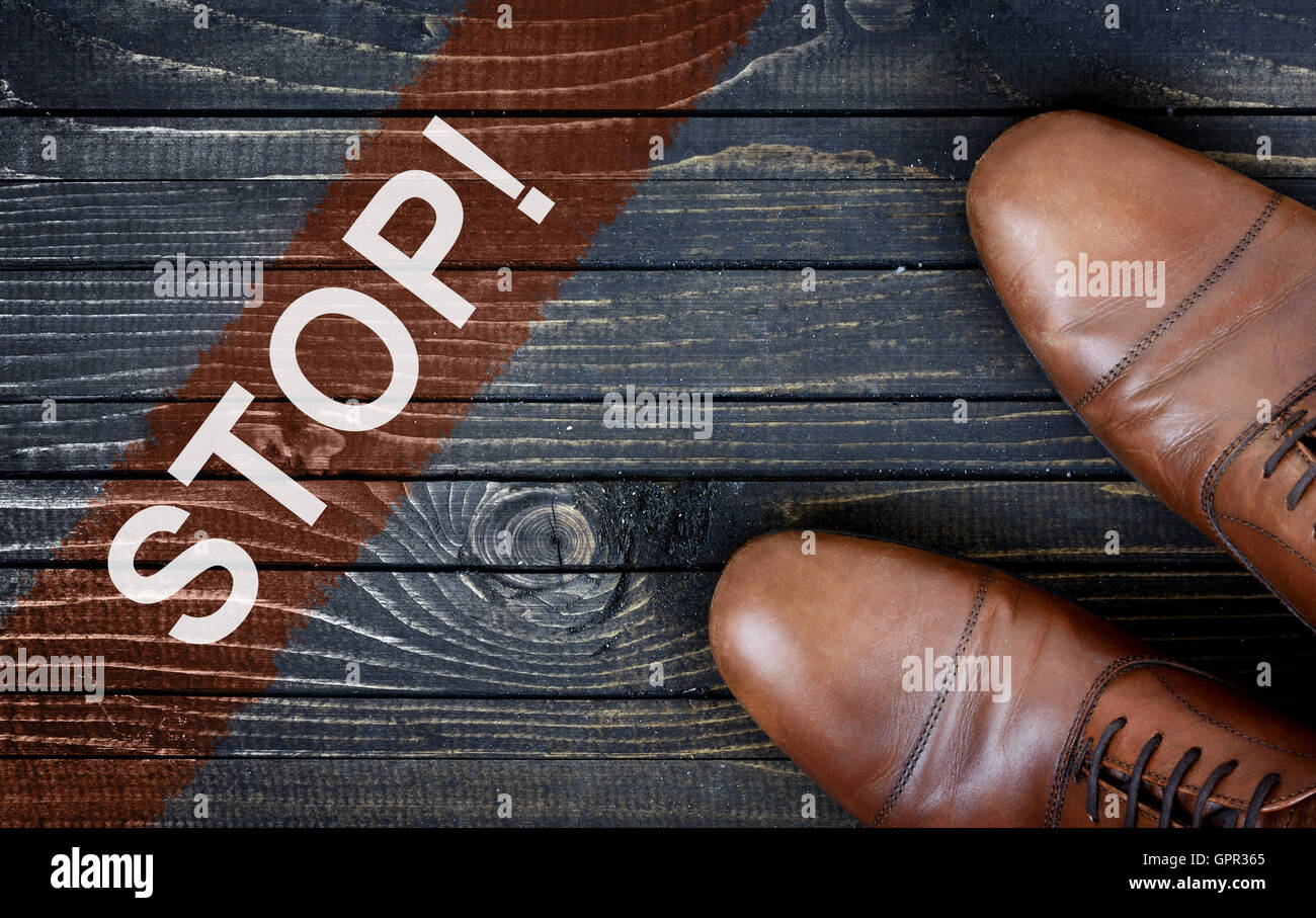 Stop message and business shoes on wooden floor Stock Photo - Alamy