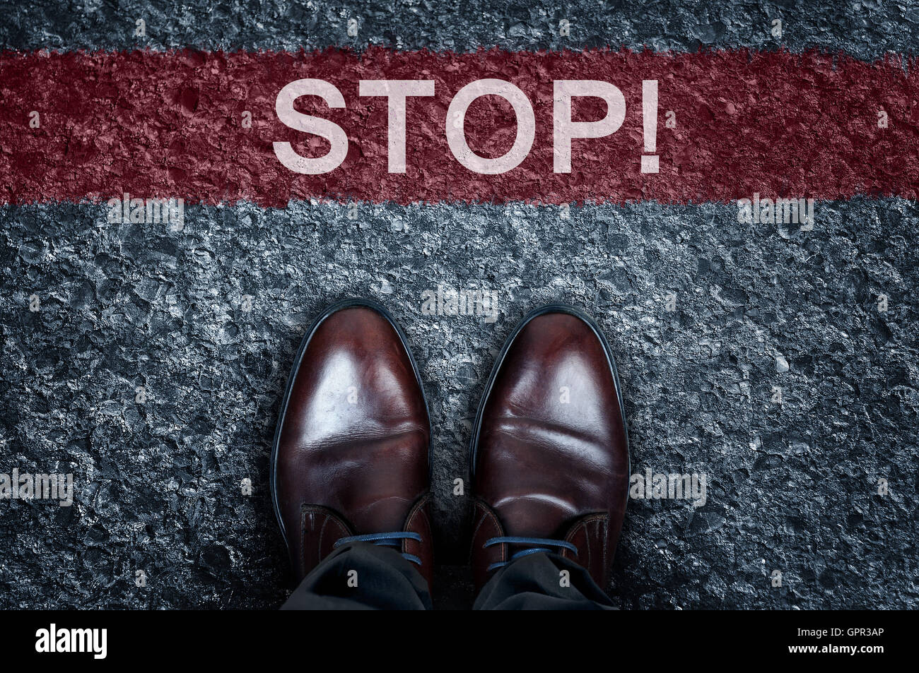 Stop message on asphalt and business shoes Stock Photo - Alamy