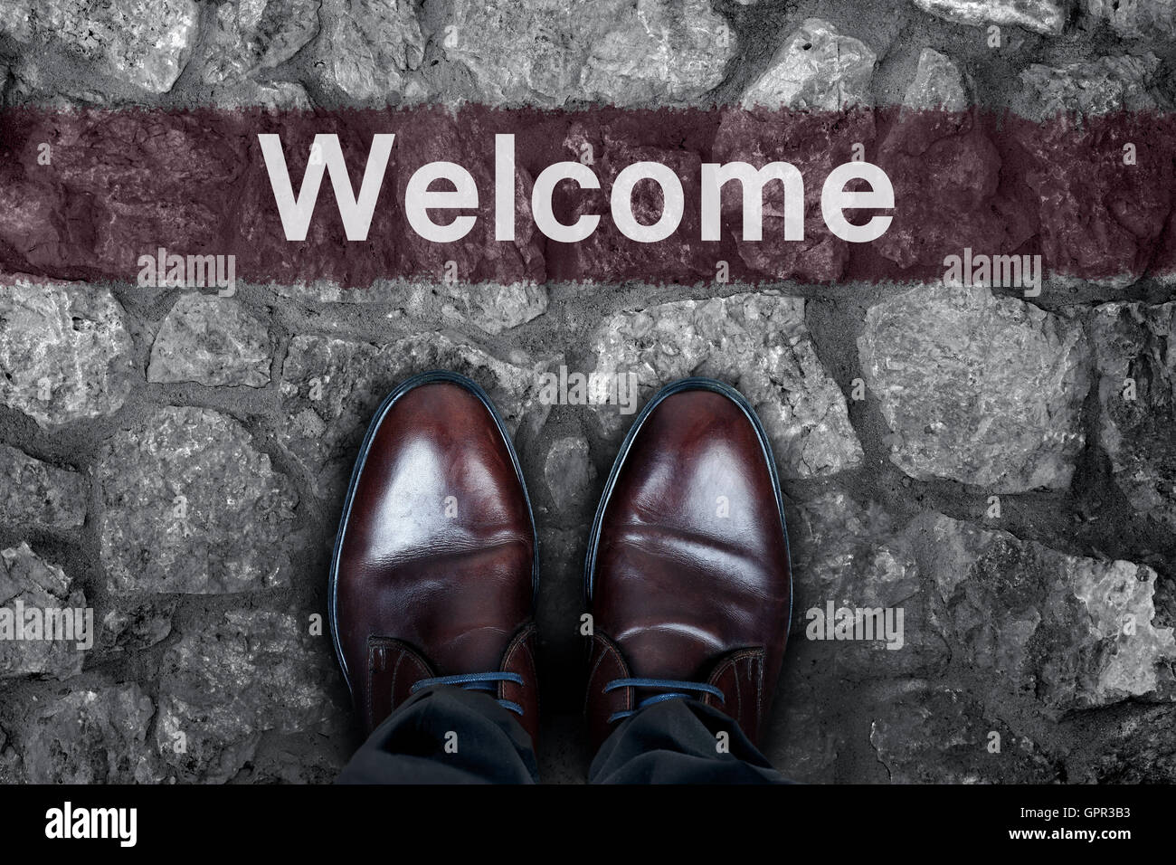 Welcome message on asphalt and business shoes Stock Photo - Alamy