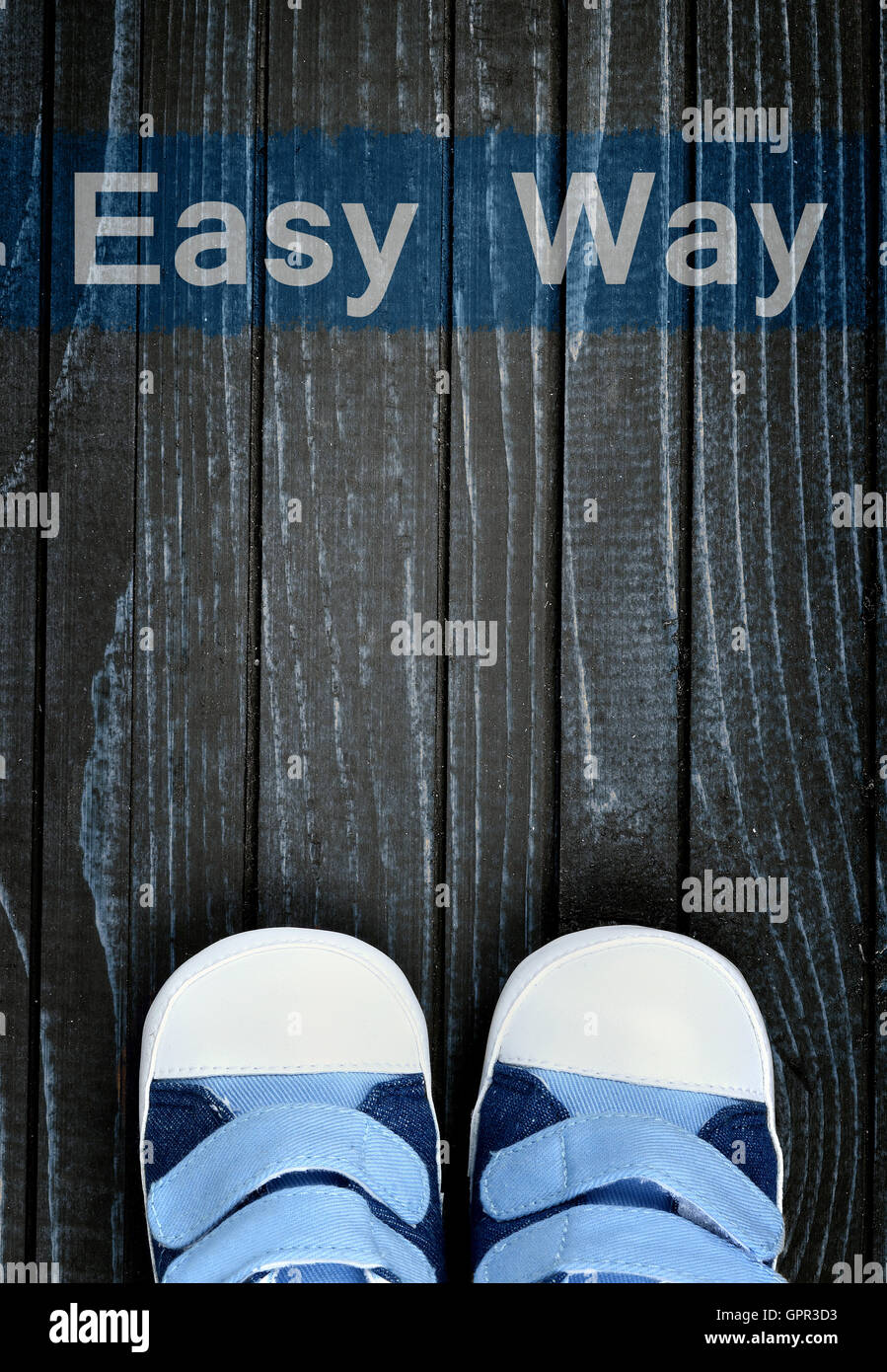 Easy Way message and kid shoes on wooden floor Stock Photo - Alamy