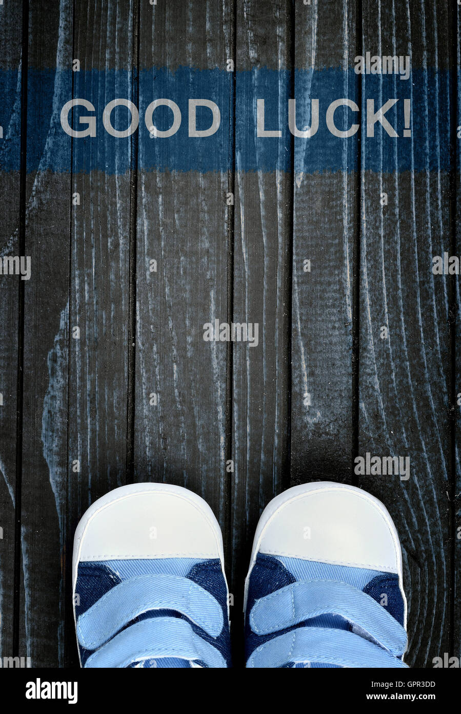 Good Luck message and kid shoes on wooden floor Stock Photo - Alamy