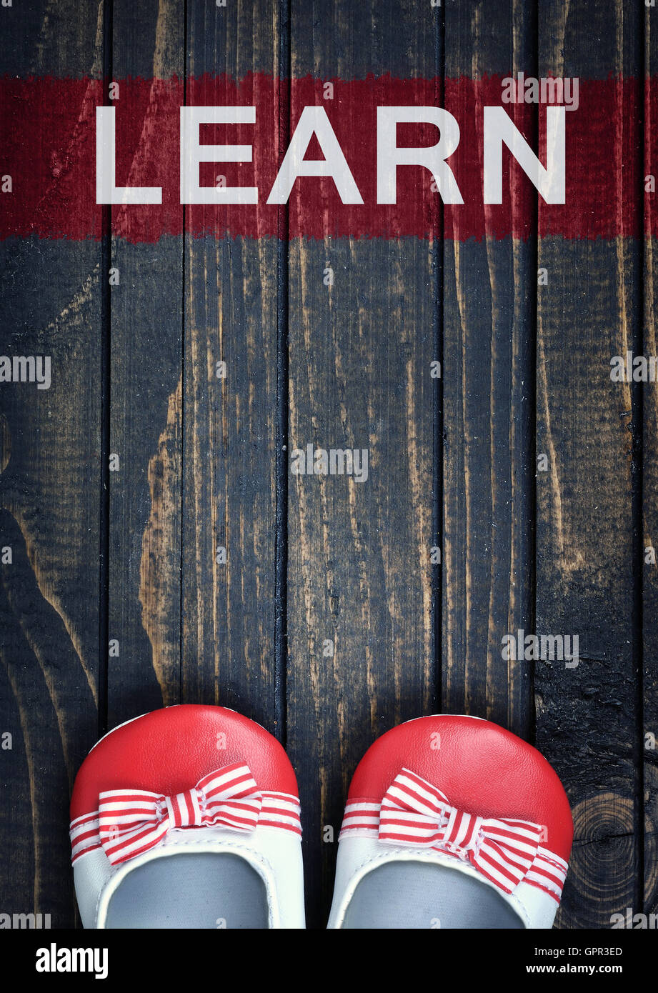 Learn message and kid shoes on wooden floor Stock Photo - Alamy