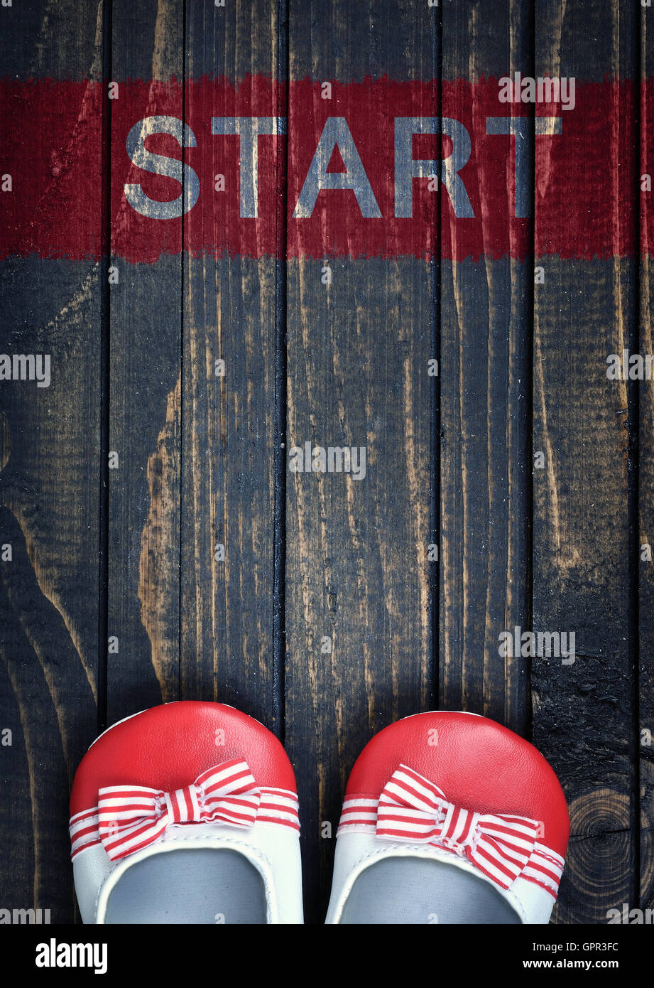 Start message and kid shoes on wooden floor Stock Photo - Alamy