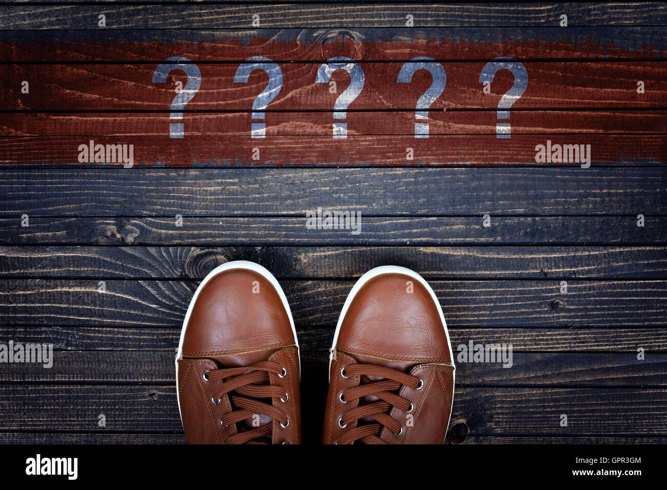 Question marks message and sport shoes on wooden floor Stock Photo - Alamy
