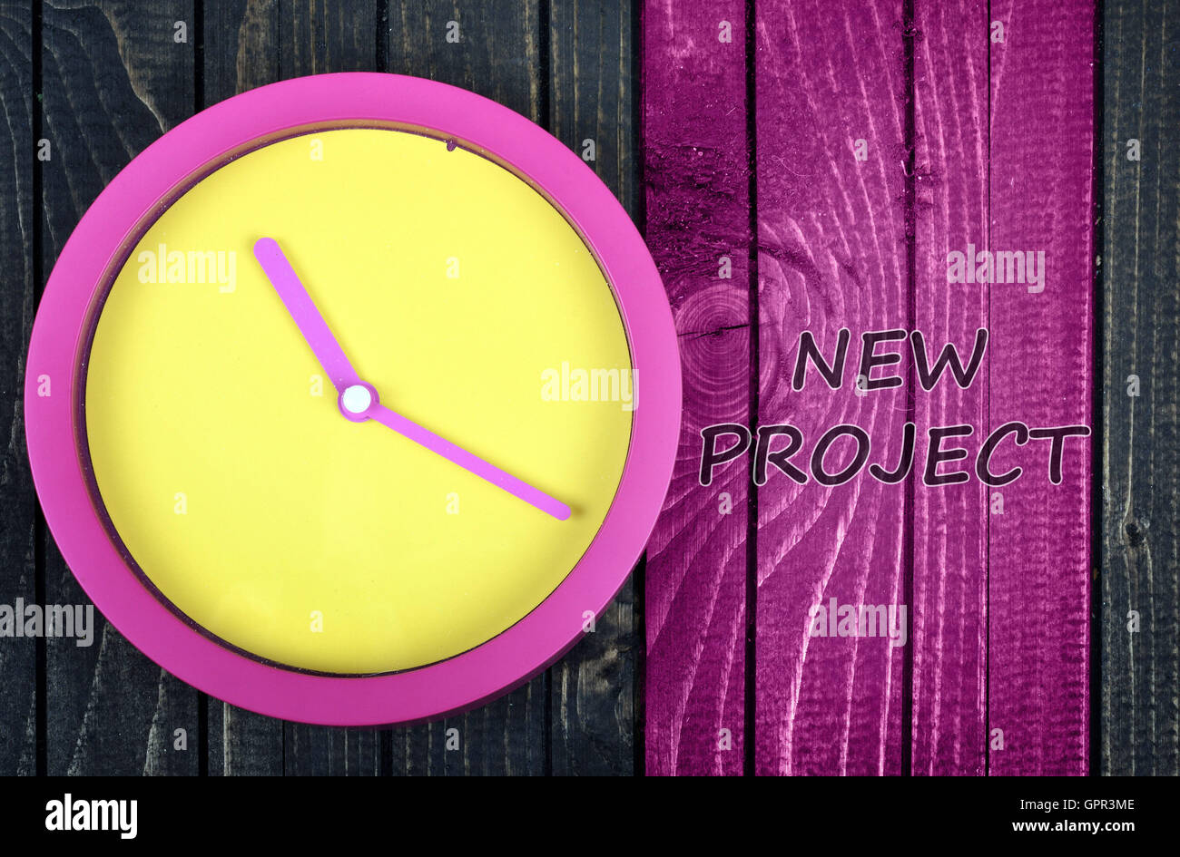 New Project message and clock on wooden table Stock Photo - Alamy