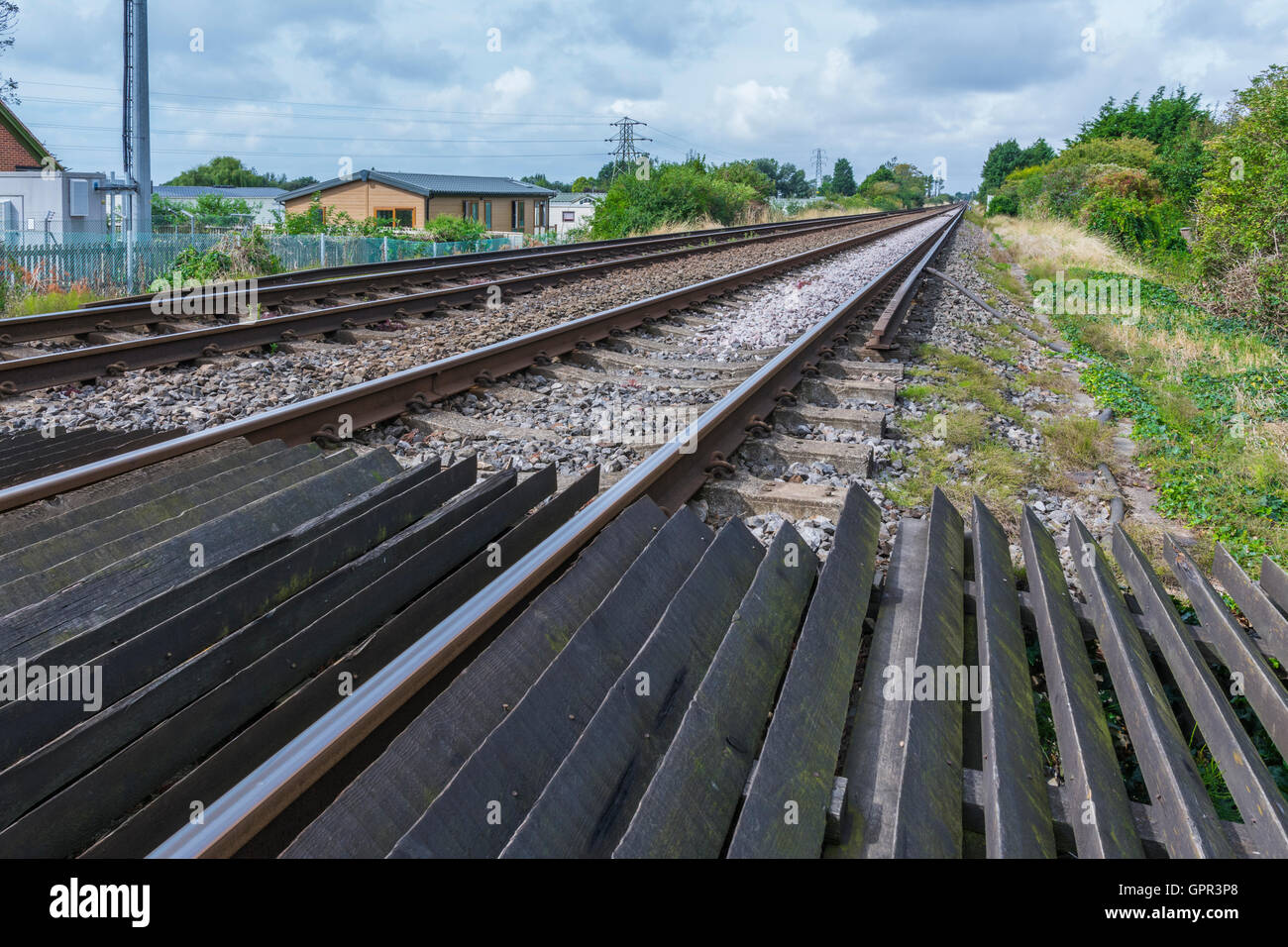 Railway tracks from low perspective looking along the track, in the UK ...