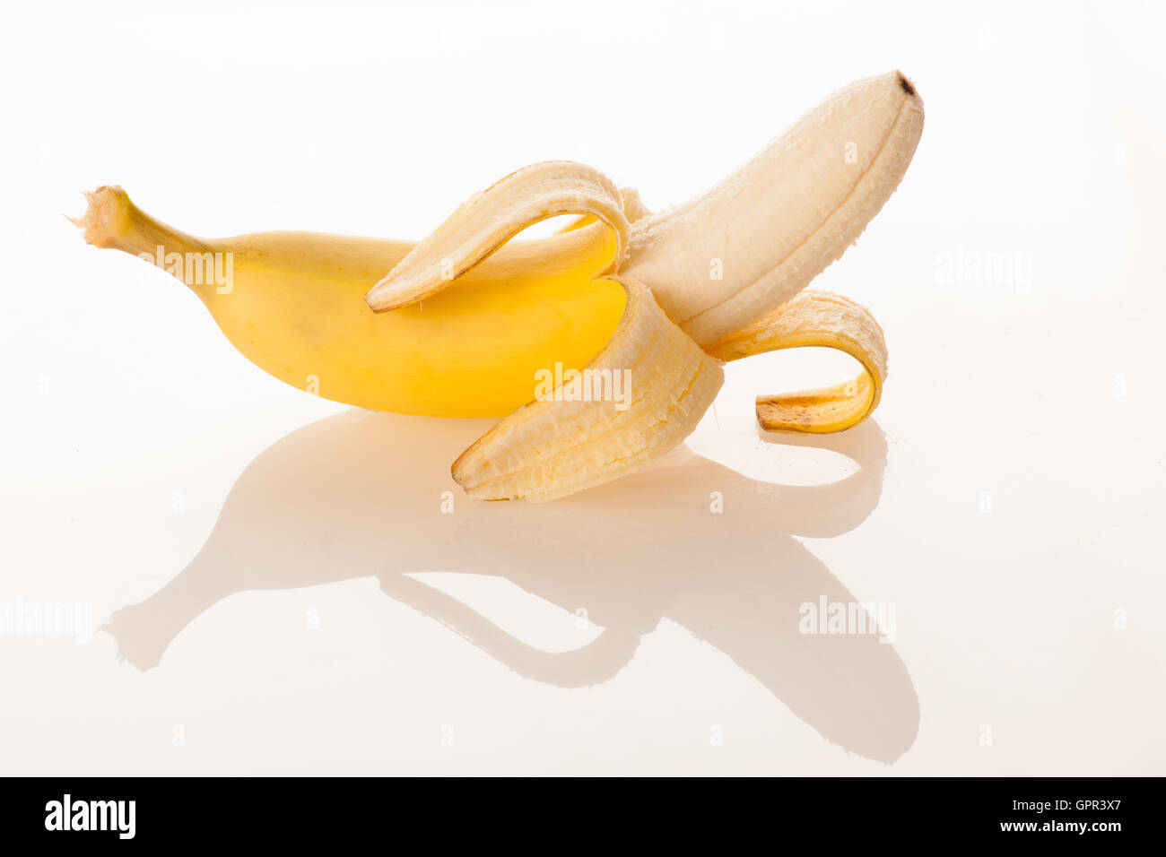 Pilled sweet banana isolated over white background Stock Photo - Alamy