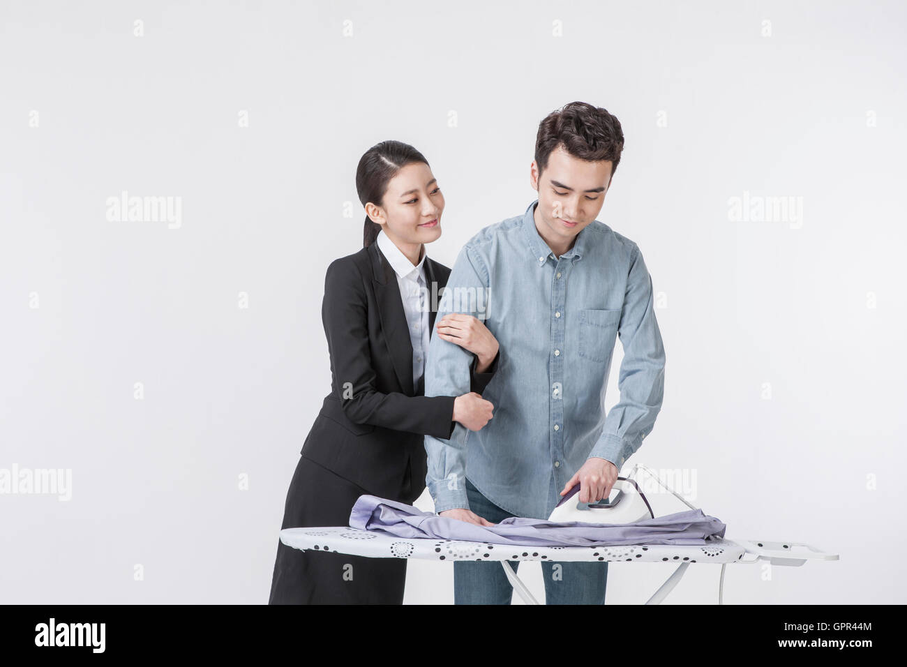 Role reversal of young couple Stock Photo - Alamy