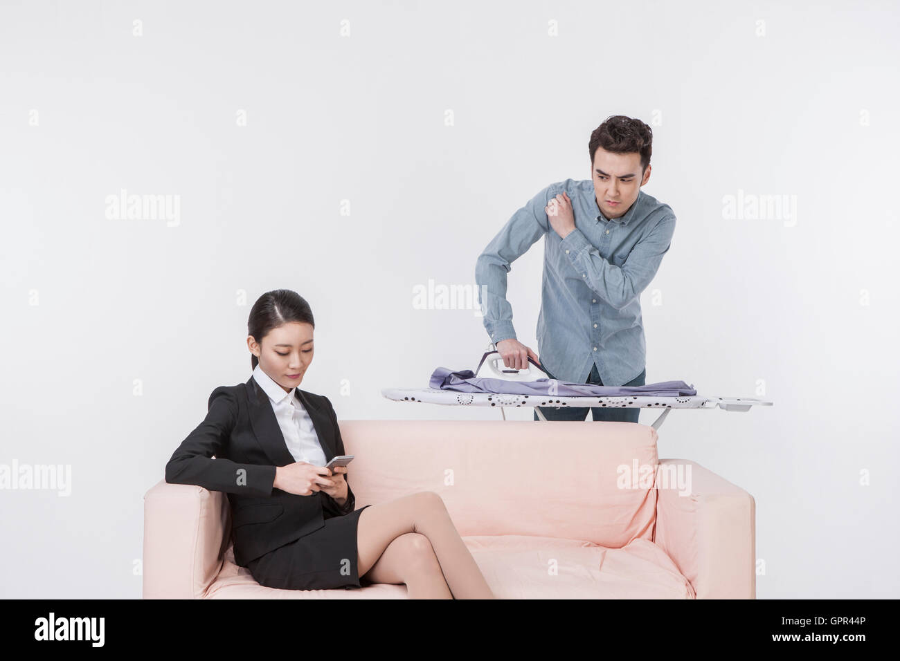 Role reversal of young couple Stock Photo - Alamy