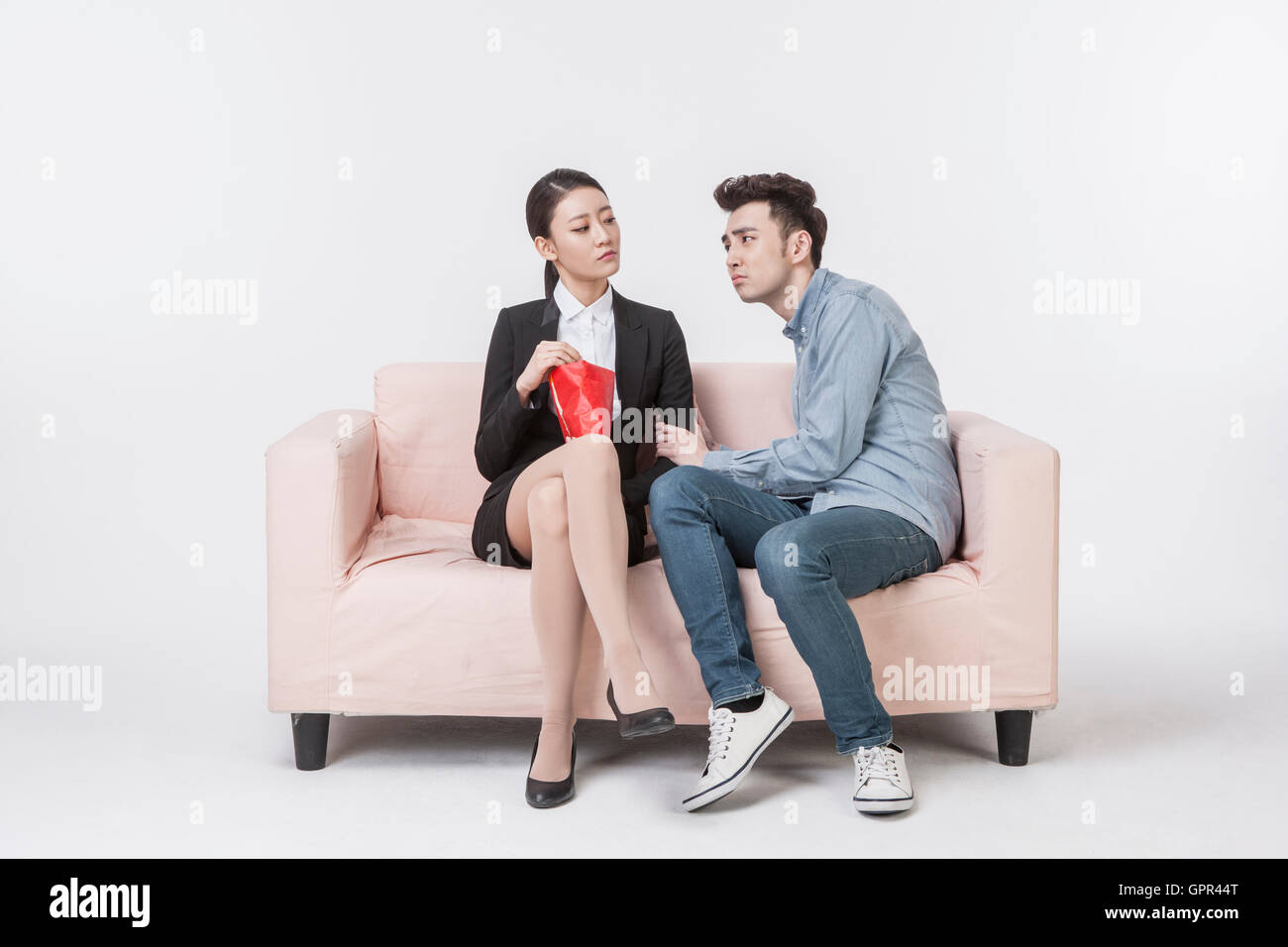 Role reversal of young couple Stock Photo - Alamy