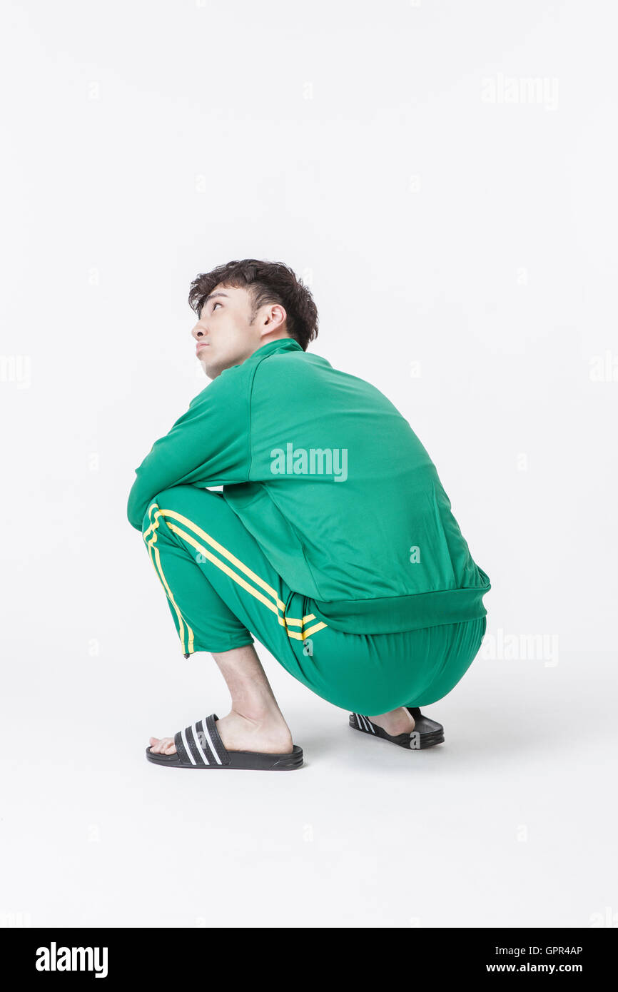 Male squatting hi-res stock photography and images - Alamy