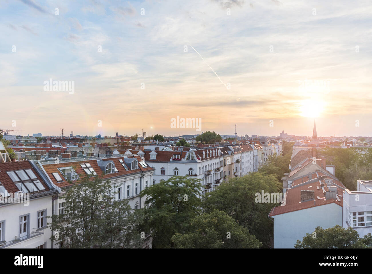 View over rooftops - city skyline at sunset Stock Photo - Alamy