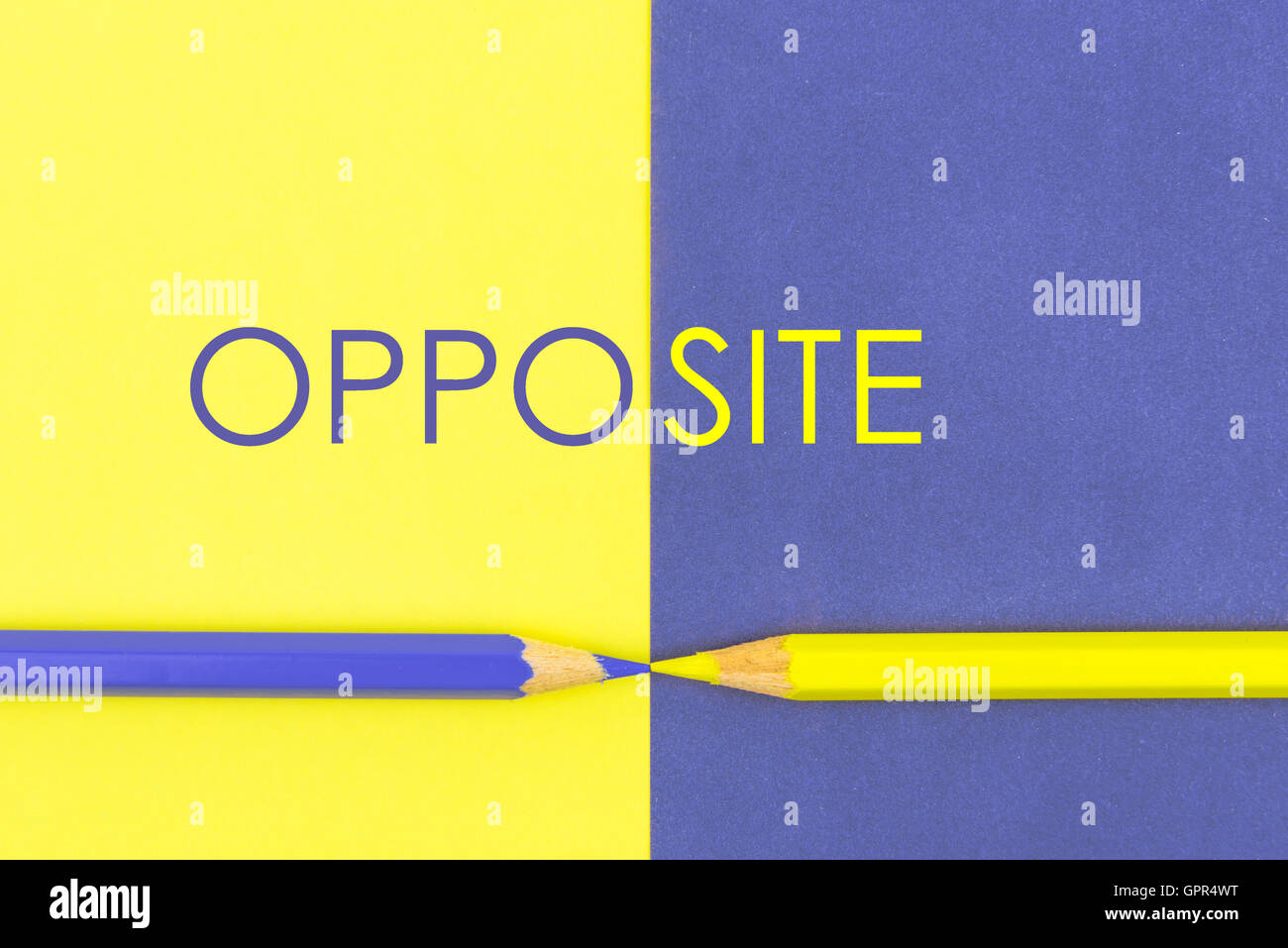 Word OPPOSITE. Yellow and Violet coloured pencils and paper, abstract ...