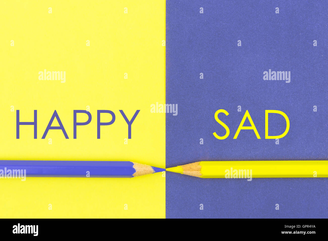 Happy versus Sad contrast concept. Yellow and Violet coloured pencils ...