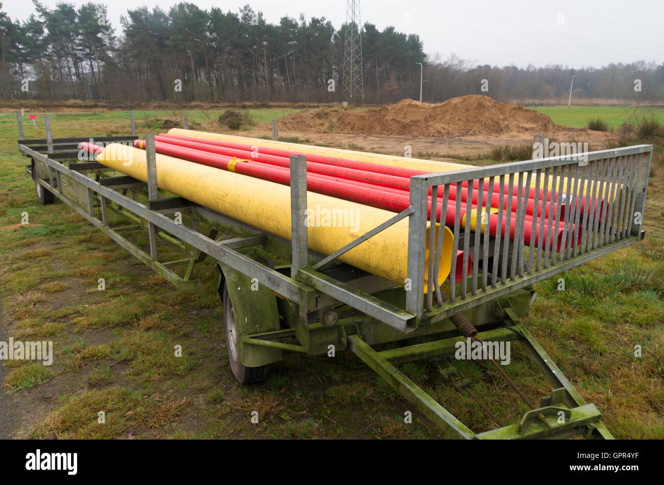 yellow and red pvc pipes on a trailer Stock Photo - Alamy