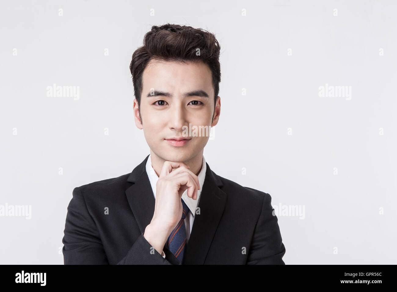 Portrait of young smiling businessman Stock Photo - Alamy