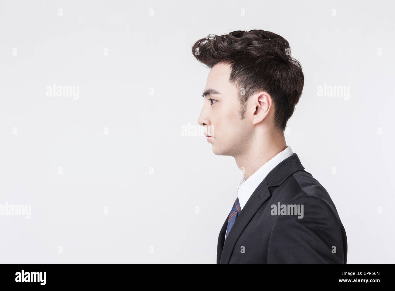 Side view portrait of young businessman Stock Photo - Alamy