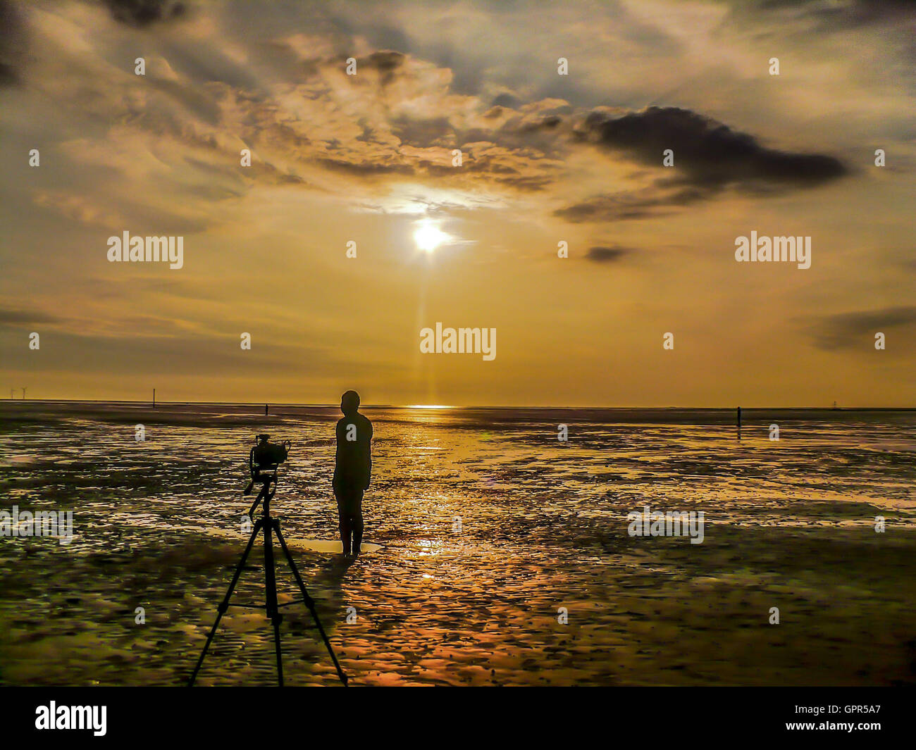 Sunset at Another Place, Crosby Beach Stock Photo - Alamy