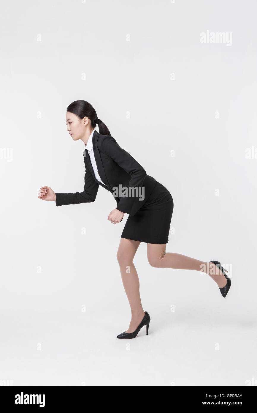 Running businesswoman hi-res stock photography and images - Alamy